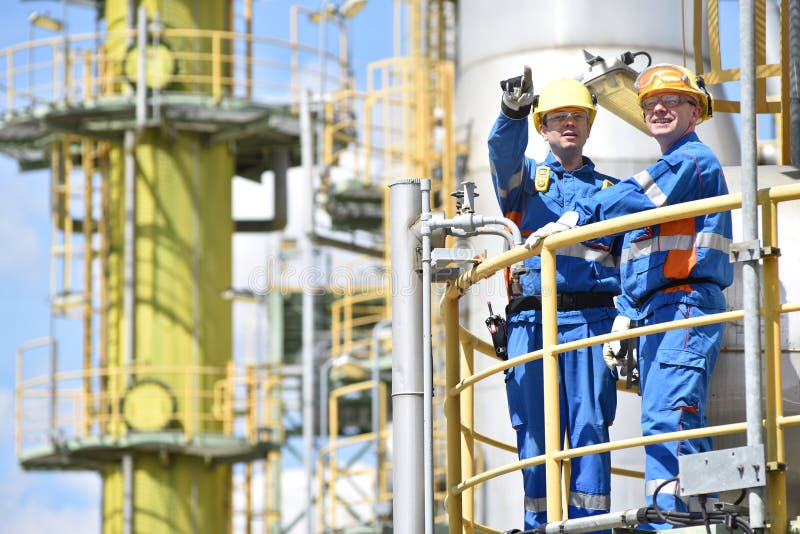 Teamwork: Group of Industrial Workers in a Refinery - Oil Processing ...