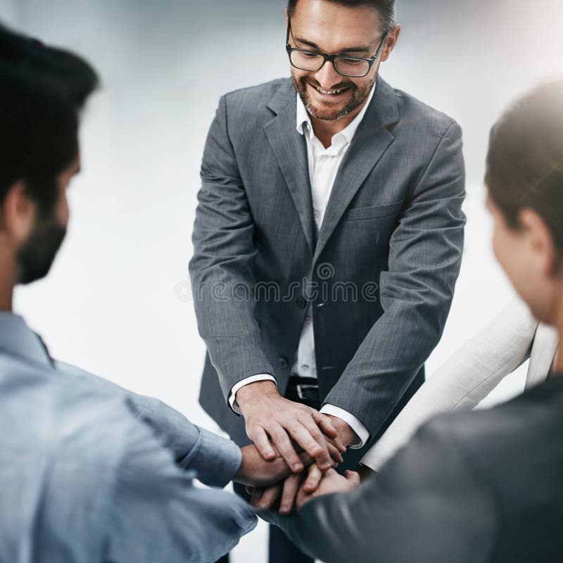 Teamwork. High Angle Shot of Three Businesspeople Standing with Their ...