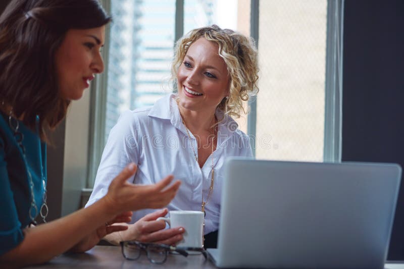Teamwork...it Just Works. Two Businesswomen Using a Laptop Together in ...