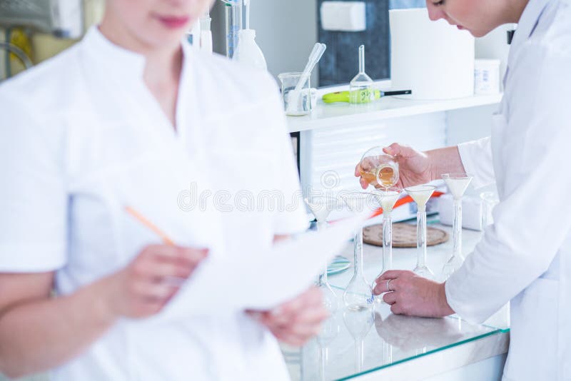Teamwork in the laboratory stock image. Image of technology - 64130403
