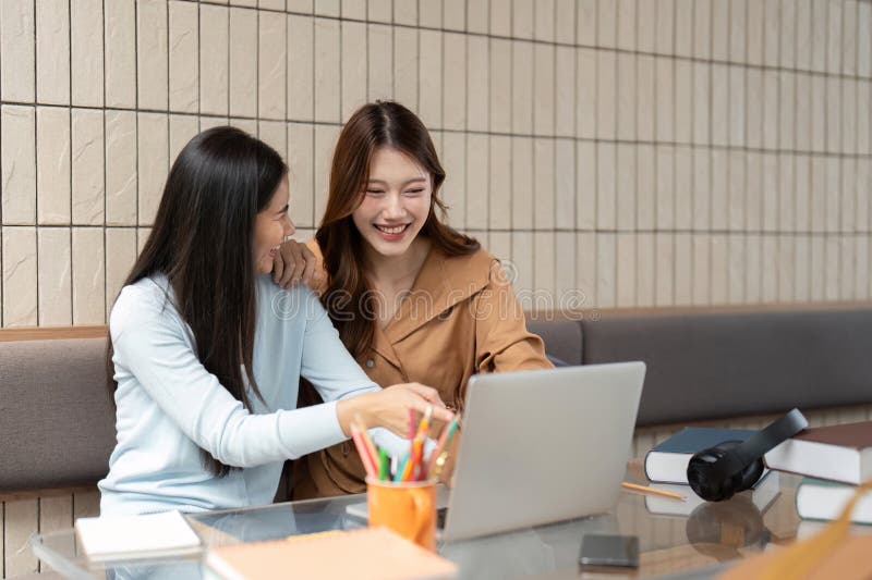 Teamwork and Learning. Two Friends Sharing Laughter and Knowledge while ...