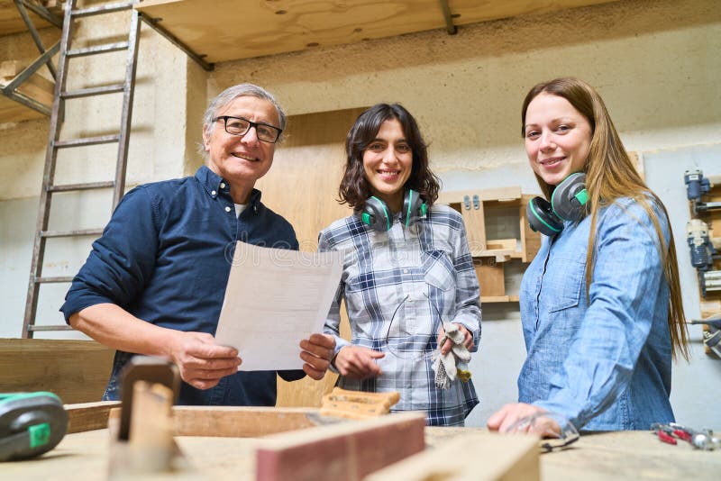 Teamwork in a Lumberyard: Young Apprentices Learning Woodworking Stock ...