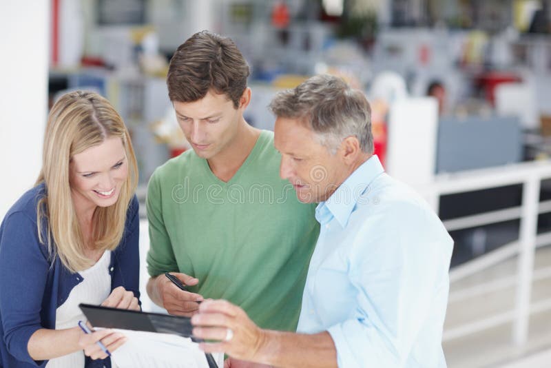 Teamwork Makes the Load Lighter. Three Work Colleagues Discussing ...