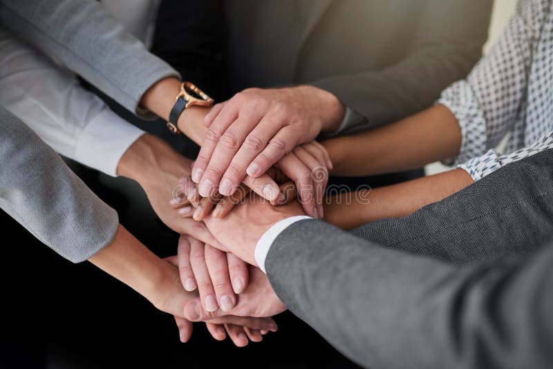 Teamwork Makes Things Happen. a Group of Colleagues Joining Hands in ...