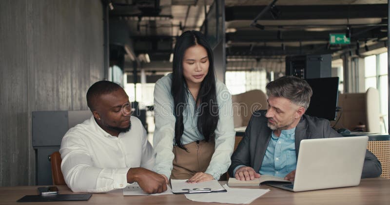 Teamwork in a Multiracial Team. the Team Discusses Their Work in the ...