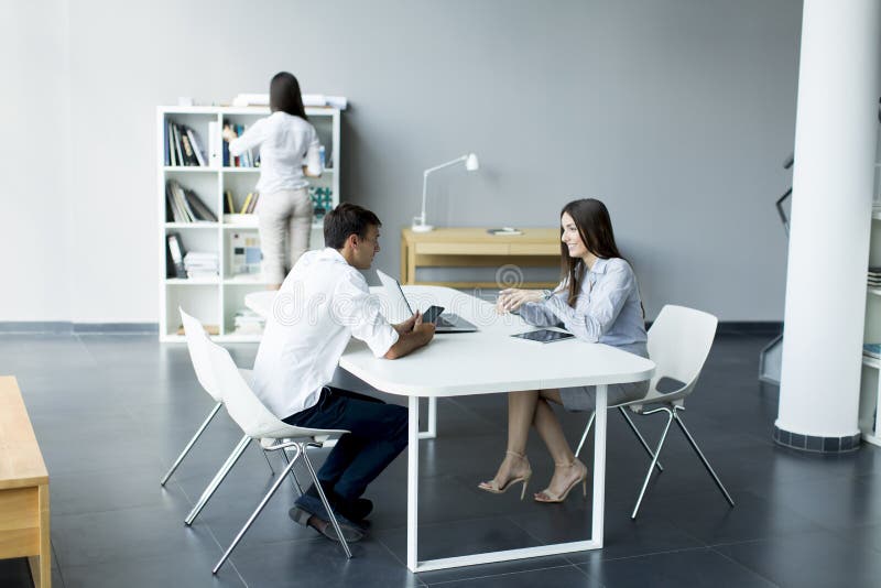 Teamwork in the office stock photo. Image of interior - 64929722