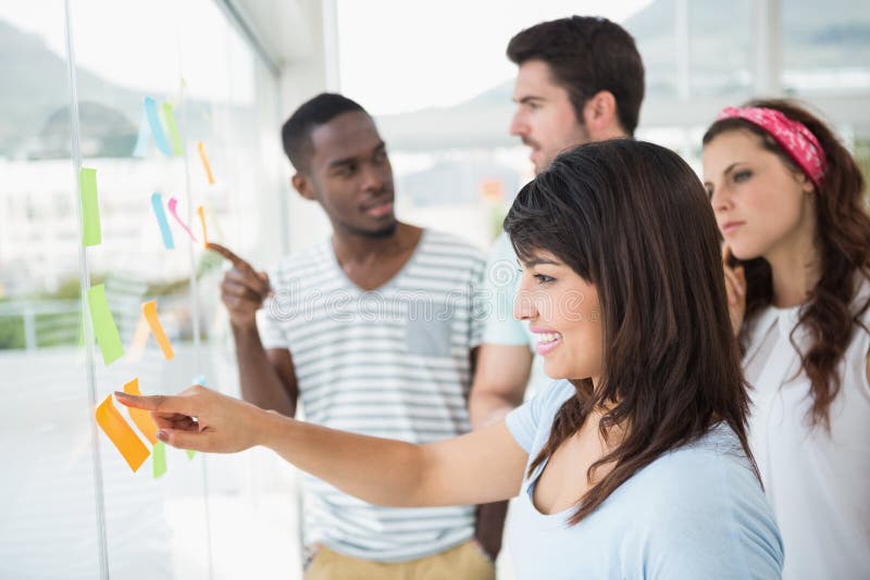 Teamwork Pointing and Reading Sticky Notes Stock Photo - Image of happy ...