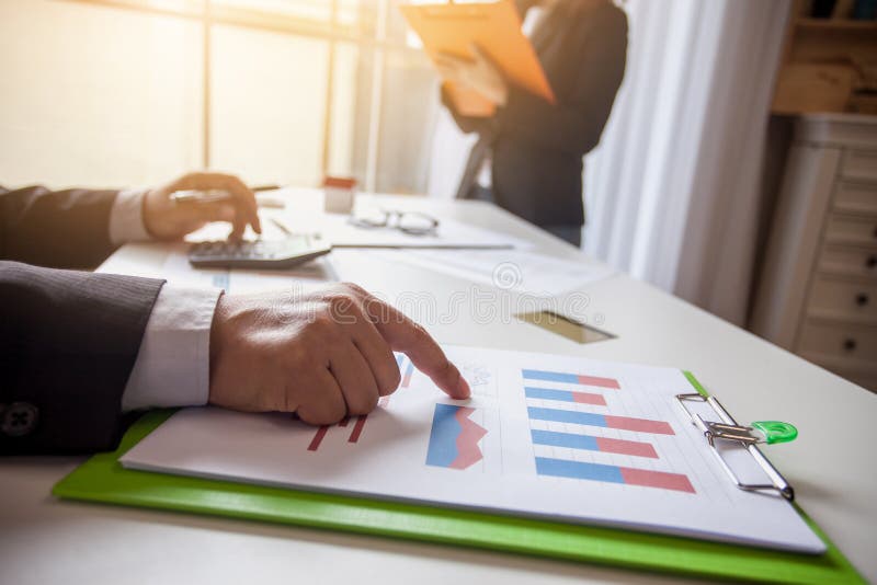 Teamwork Process, Business Team Using a Calculator To Calculate and ...