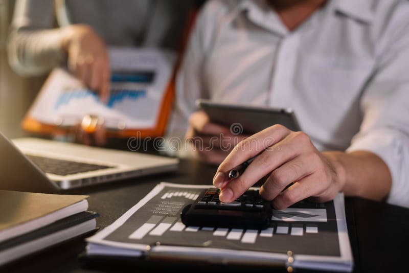 Business Team Using a Calculator To Calculate the Numbers of Statistic ...