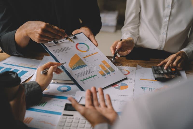 Teamwork Process, Business Team Using a Calculator To Calculate the ...