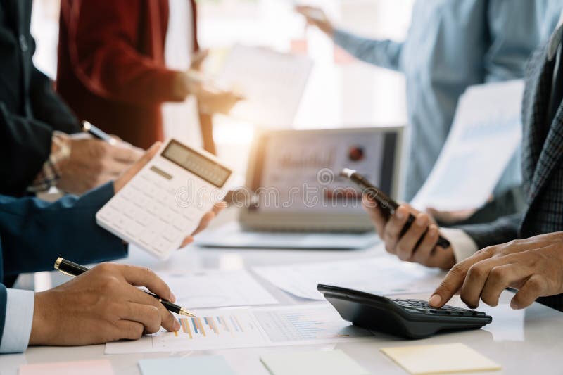 Teamwork Process, Business Team Using a Calculator To Calculate the ...