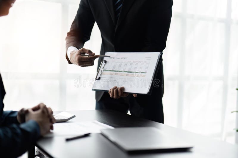 Teamwork Process, Business Team Using a Calculator To Calculate the of ...