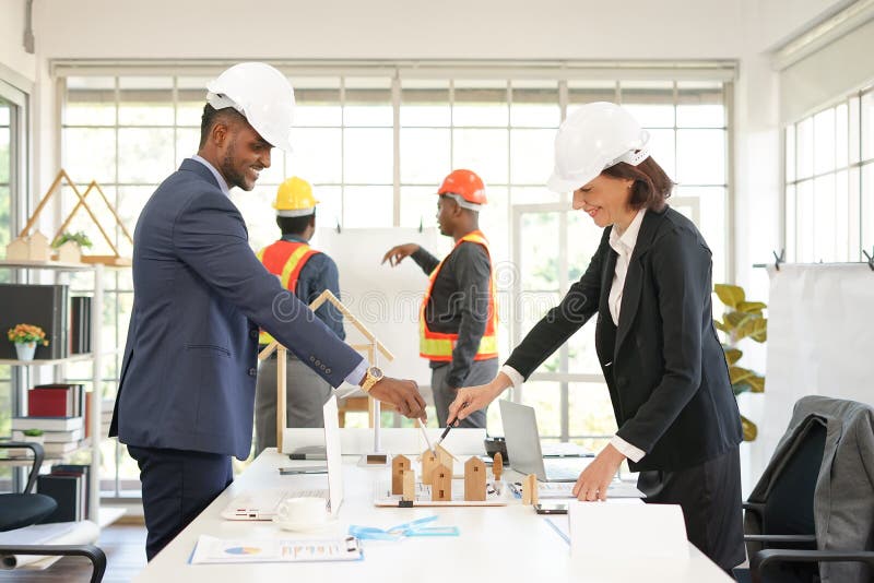 Teamwork and Project Management Engineers Discussing Project Together ...