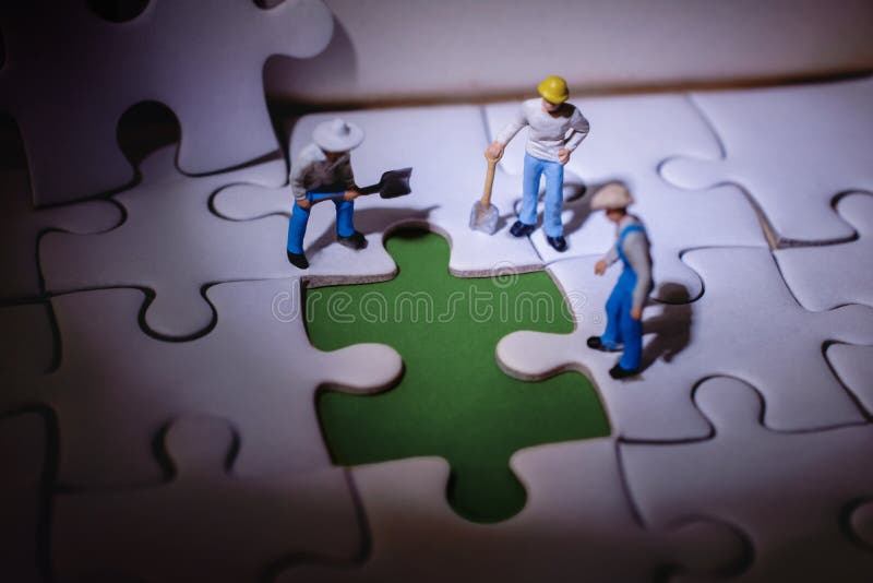 Teamwork and Solving Problem Concept. Group of Miniature Worker Men ...