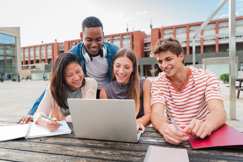 Teamwork of Teenage Students Using a Laptop To Prepare a Exam. Group of ...
