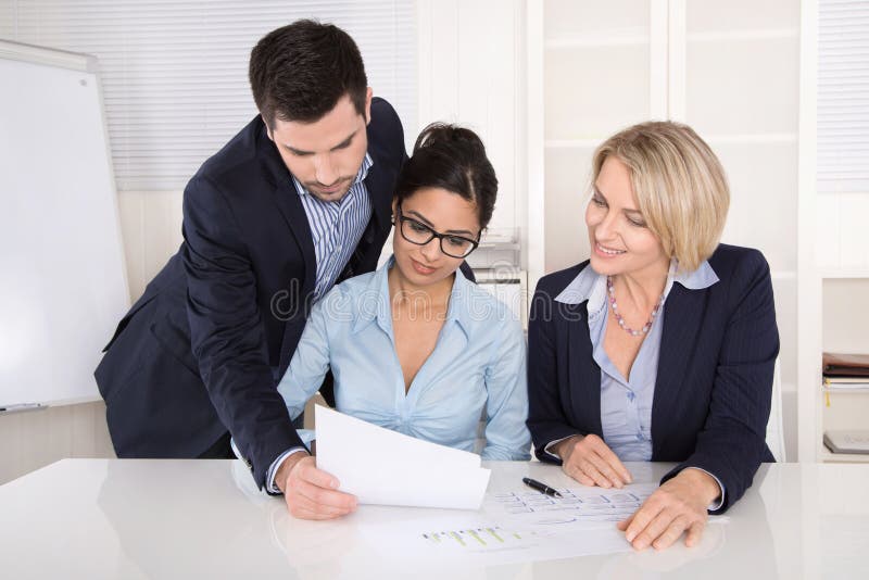 Teamwork between Three Business People at Desk at Office. Stock Photo ...