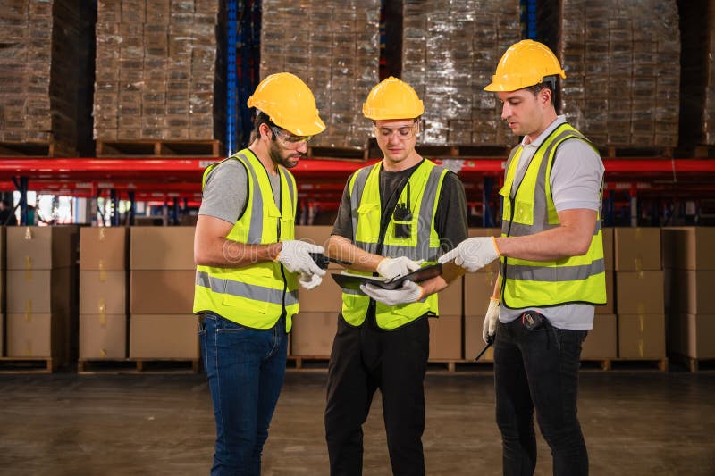Teamwork of Three Warehouse Workers in Uniform Wearing Yellow Safety ... Teamwork of Three Warehouse Workers in Uniform Wearing Yellow Safety ...