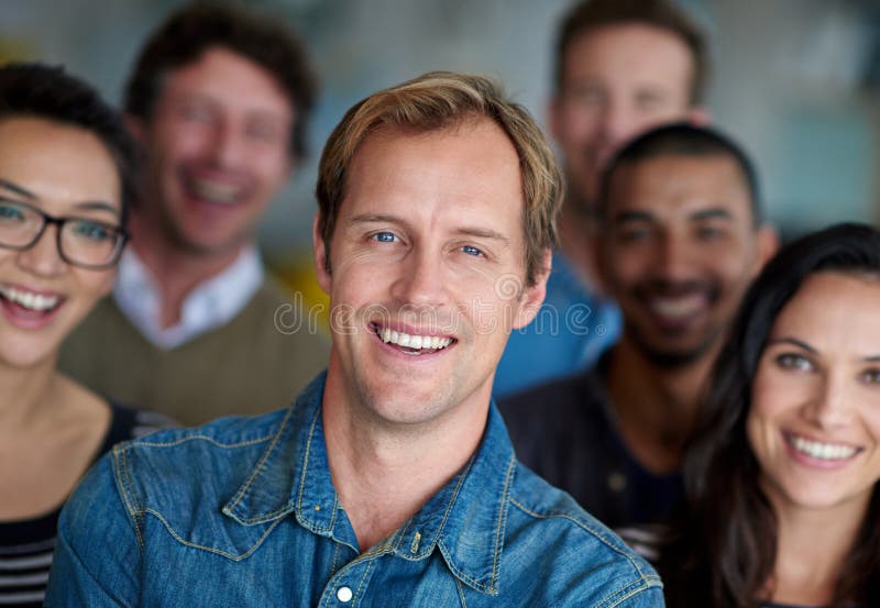 Teamwork and Togetherness. a Smiling Group of Coworkers Standing in an ...