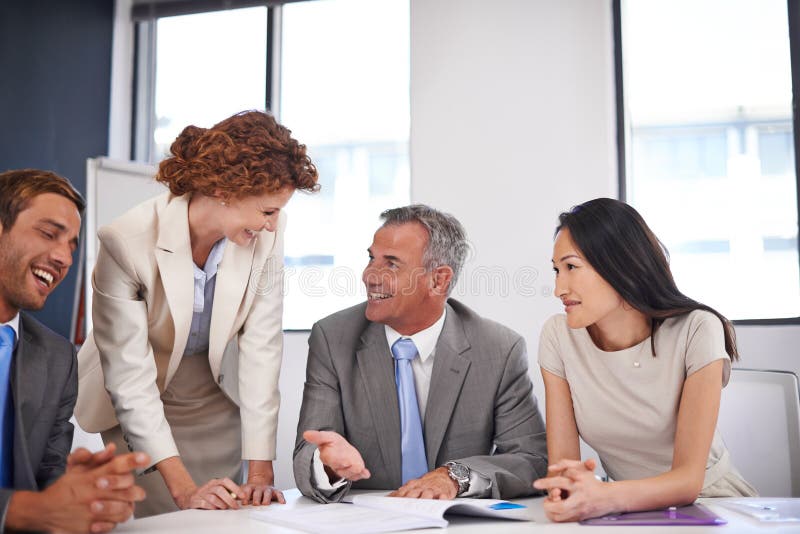 Teamwork in the Workplace. a Group of Businesspeople in a Boardroom ...