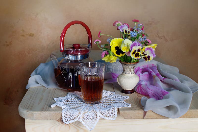 A Teapot and a Cup of Tea with a Bouquet of Spring Flowers Stock Photo ...
