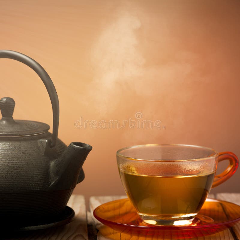 Teapot and a Cup of Tea on an Old Wooden Table - Hot Steam Smoking from ...