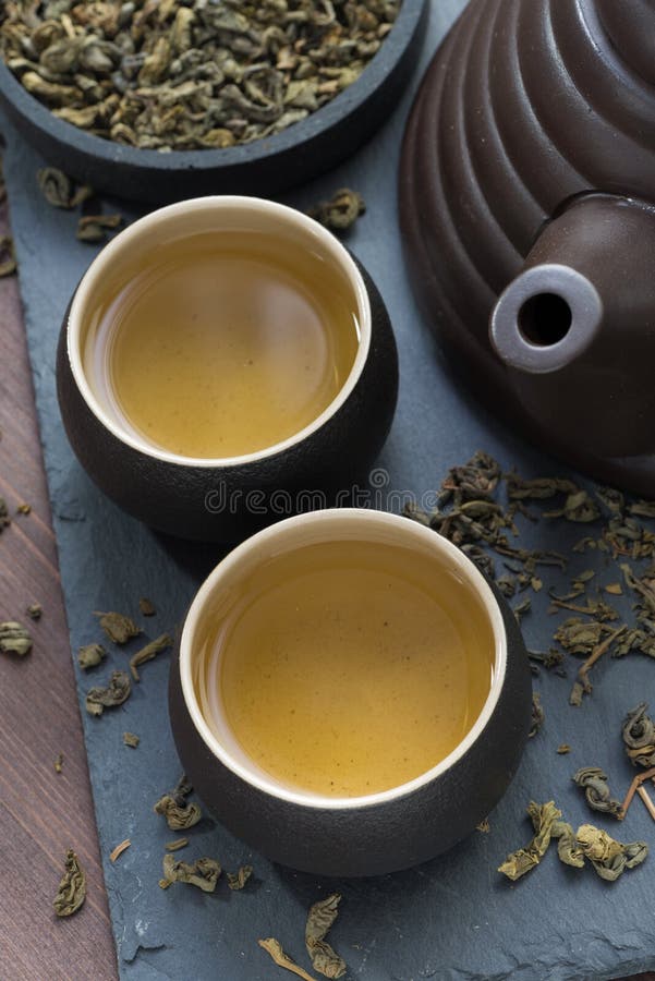 Teapot and Cups with Green Tea, Vertical Stock Image - Image of ...