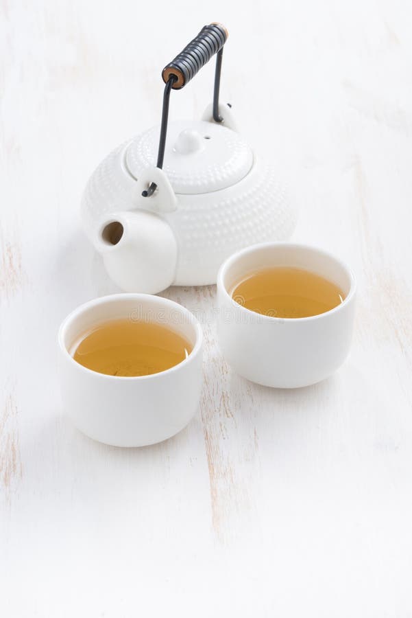Teapot and Cups of Green Tea on a White Wooden Table, Vertical Stock ...