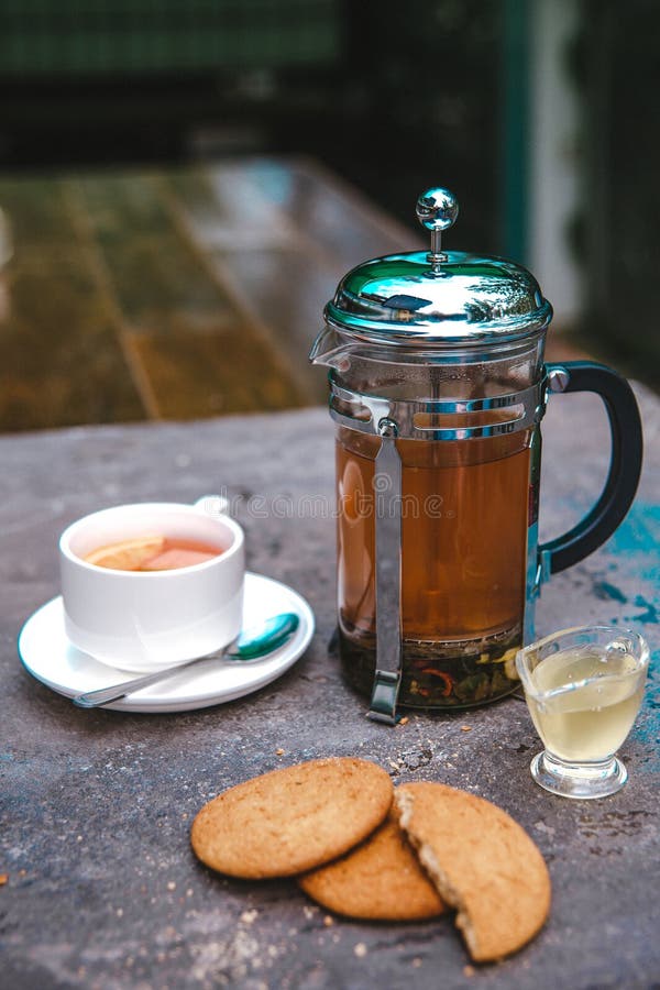 Teapot and Mugs with Cookies on the Table of the Summer Cafe Stock ...