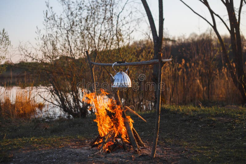 Teapot with Tea Hangs Over the Fire on the Riverbank Sunset Stock Image ...