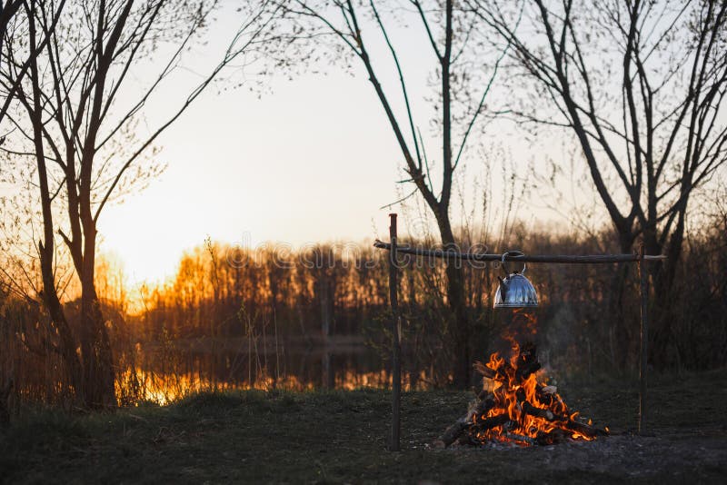 Teapot with Tea Hangs Over the Fire on the Riverbank Sunset Stock Image ...