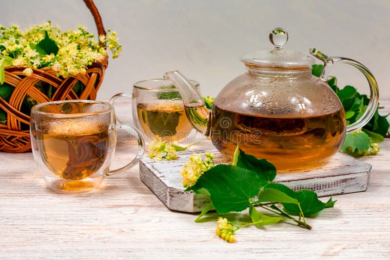 Teapot and Two Cups of Tea with a Linden Tree on a Wooden Table ...