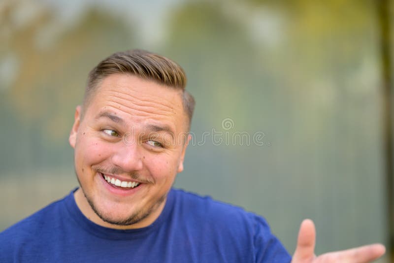 Teasingly Smiling Young Man Pointing at Someone Stock Photo - Image of ...