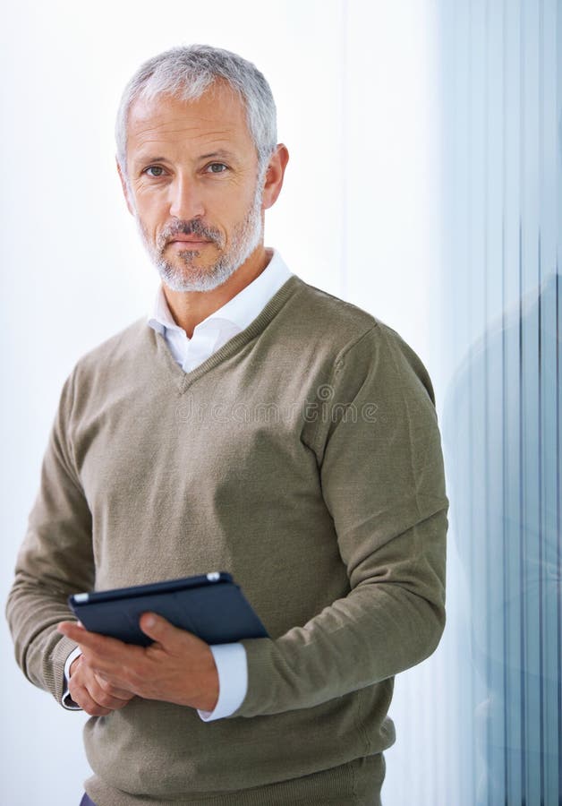 Tech for the Modern Exec. Portrait of a Mature Businessman Standing ...