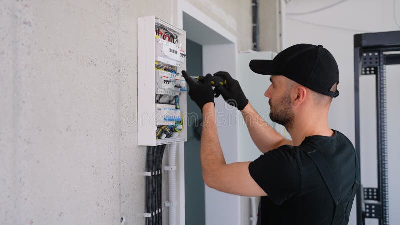 Technical Electrician Fixing the Cable into the Terminal of a Circuit ...