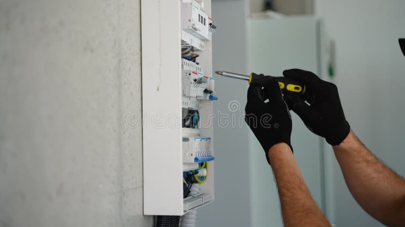 Technical Electrician Fixing the Cable into the Terminal of a Circuit ...