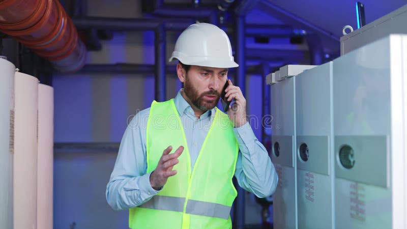 Tech Manager on Phone in Boiler Room Quality Control Checks on Heating ...