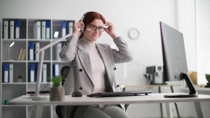 Technical Support, Charming Smiling Woman Puts on a Headset To ...