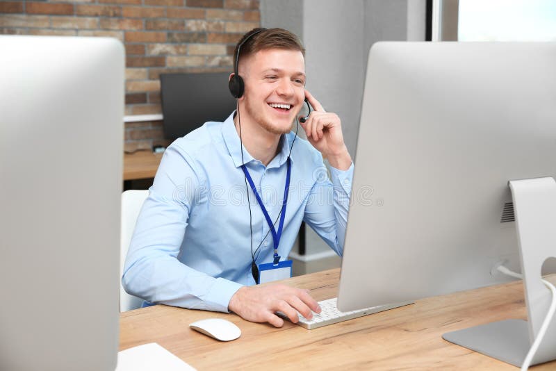 Technical Support Operator Working with Headset and Computer at Table ...