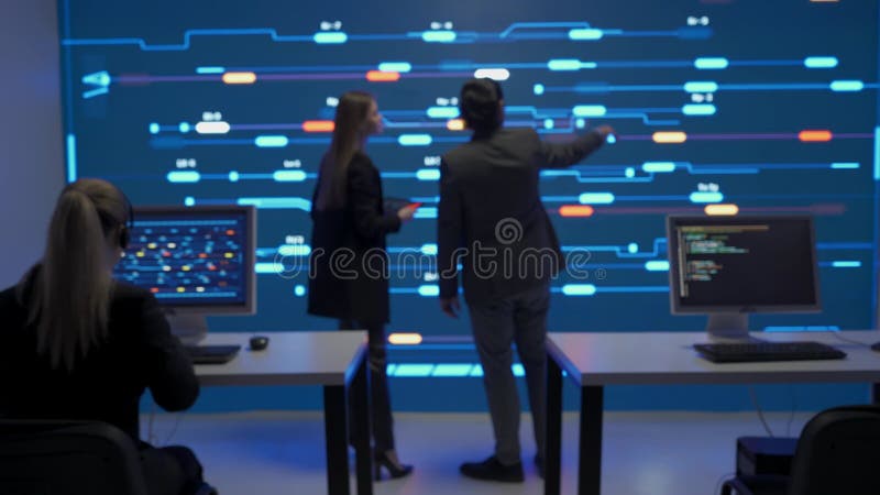 Technical Support Team in Control Room. Man and Woman Specialists ...