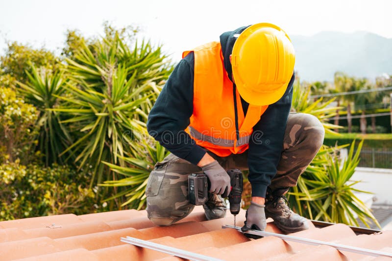 Technical Worker Works with Drill on the Roof of a House Stock Image ...