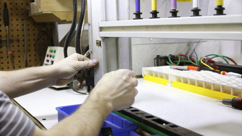 A Technician Adjusting the Settings on an Advanced Injection Molding ...