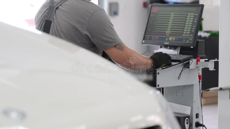 Auto Mechanic Aligns Car Wheels Using Precision Computerized Equipment ...