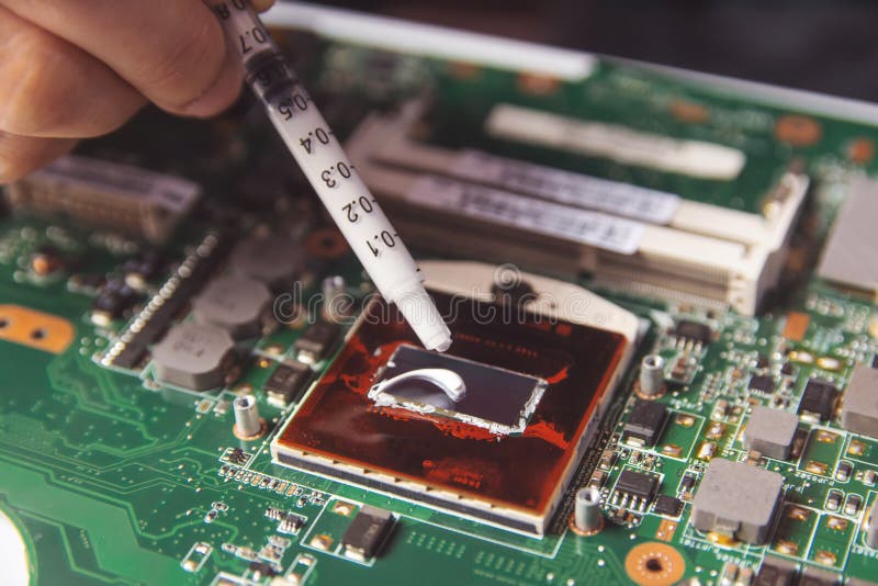 Technician Applying Thermal Paste with Syringe on the GPU Processor on ...