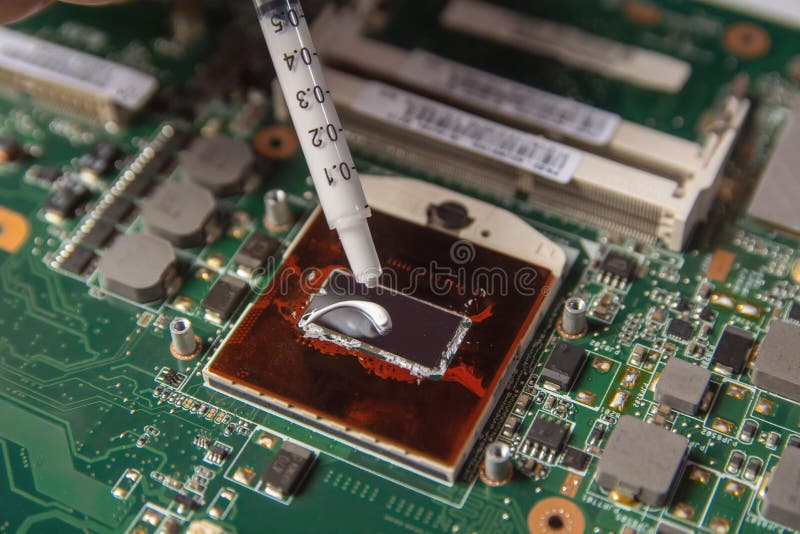 Technician Applying Thermal Paste with Syringe on the CPU Processor on ...