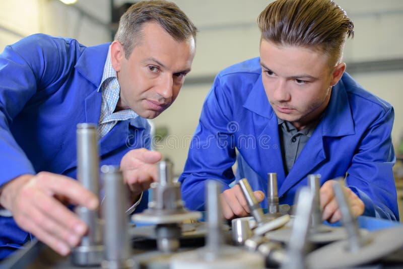 2 Technician Appraising Mechanical Parts Stock Photo - Image of ...