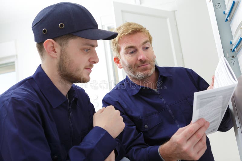 Technician and Apprentice at Cable Wiring Work Stock Photo - Image of ...