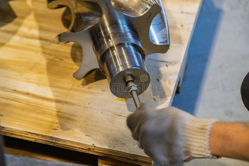 Technician Assembling Industrial Part Using a Threaded Rod Stock Photo ...