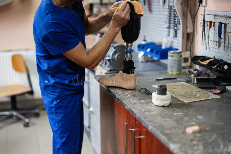 Technician Assembling a Prosthetic Leg in Workshop Setting Stock Image ...