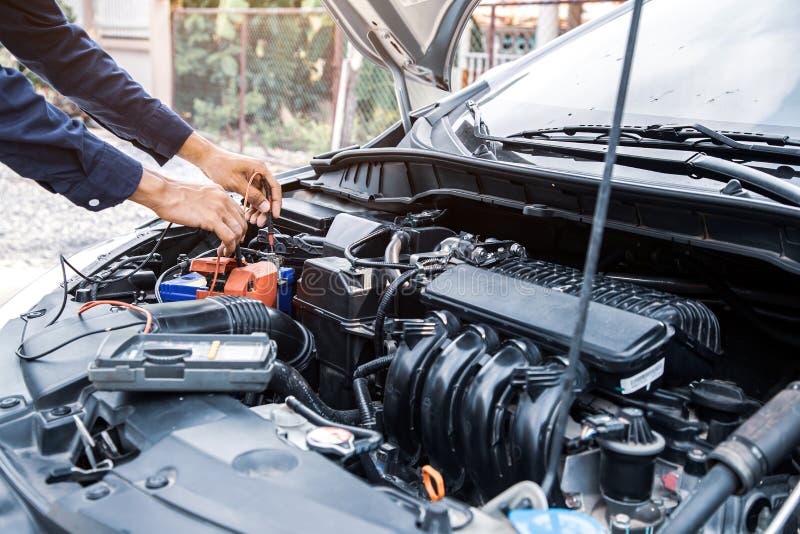 Technician Auto Mechanic Using a Power Meter To Check the Car Battery ...