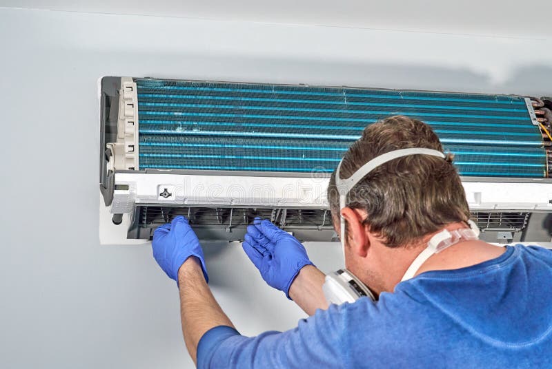 Engineer in Blue Gloves and Mask Cleaning Gree Dirty Air Conditioner ...
